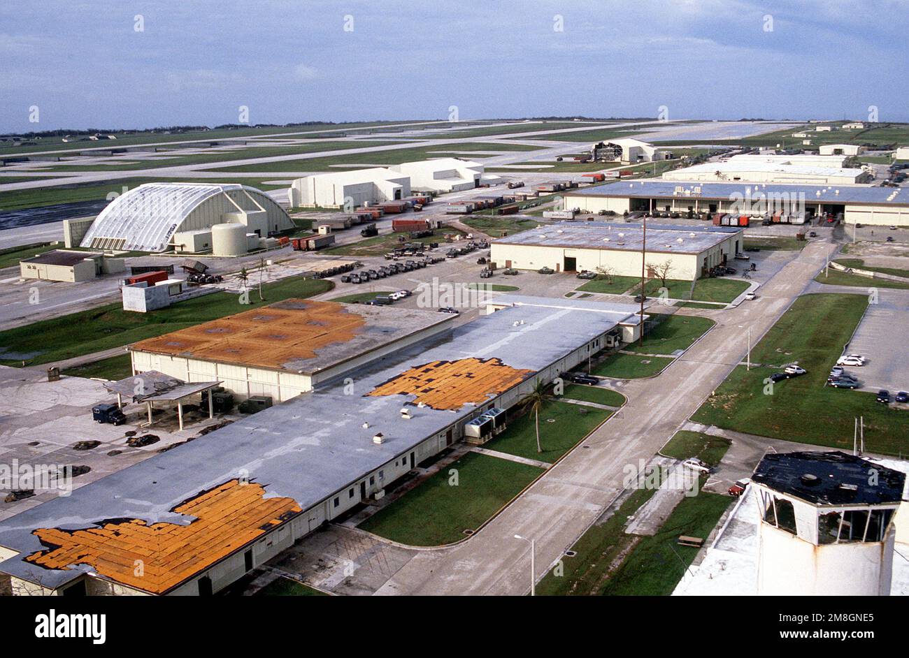 Hangars and other buildings display the effects of Typhoon Omar, which ...