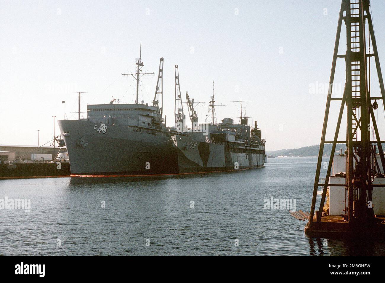A port bow view of the destroyer tender USS CAPE CODE (AD-43) and the ...