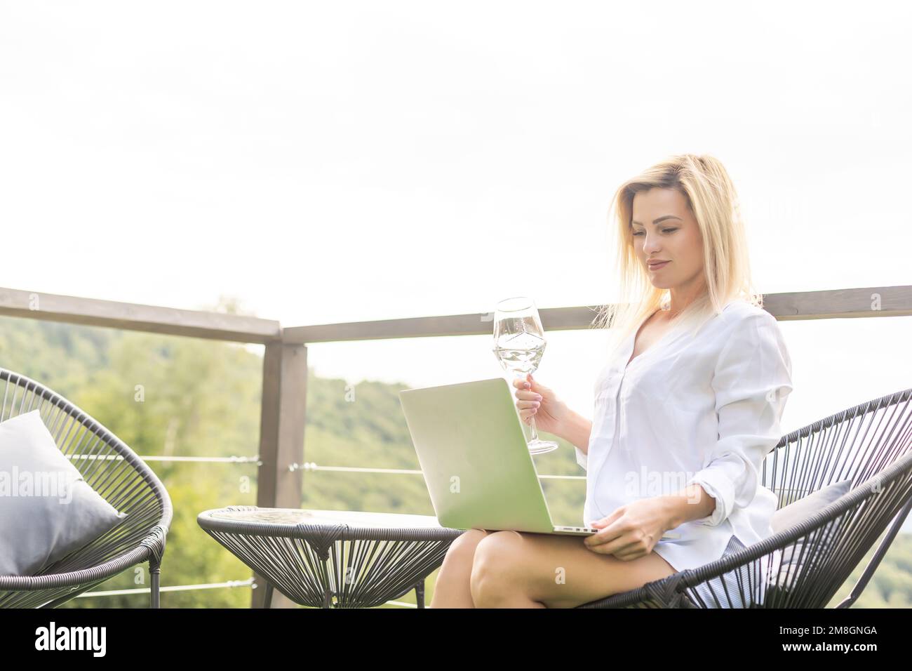 Successful positive business woman is sitting on an outdoor terrace ...