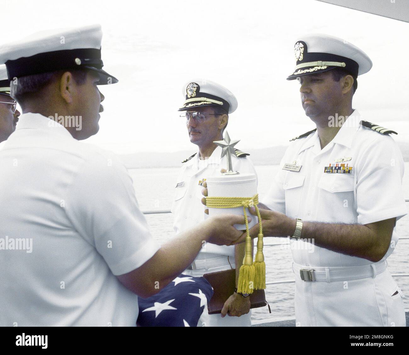 MCPO Charles Cartwright presents the urn containing the remains of CDR ...