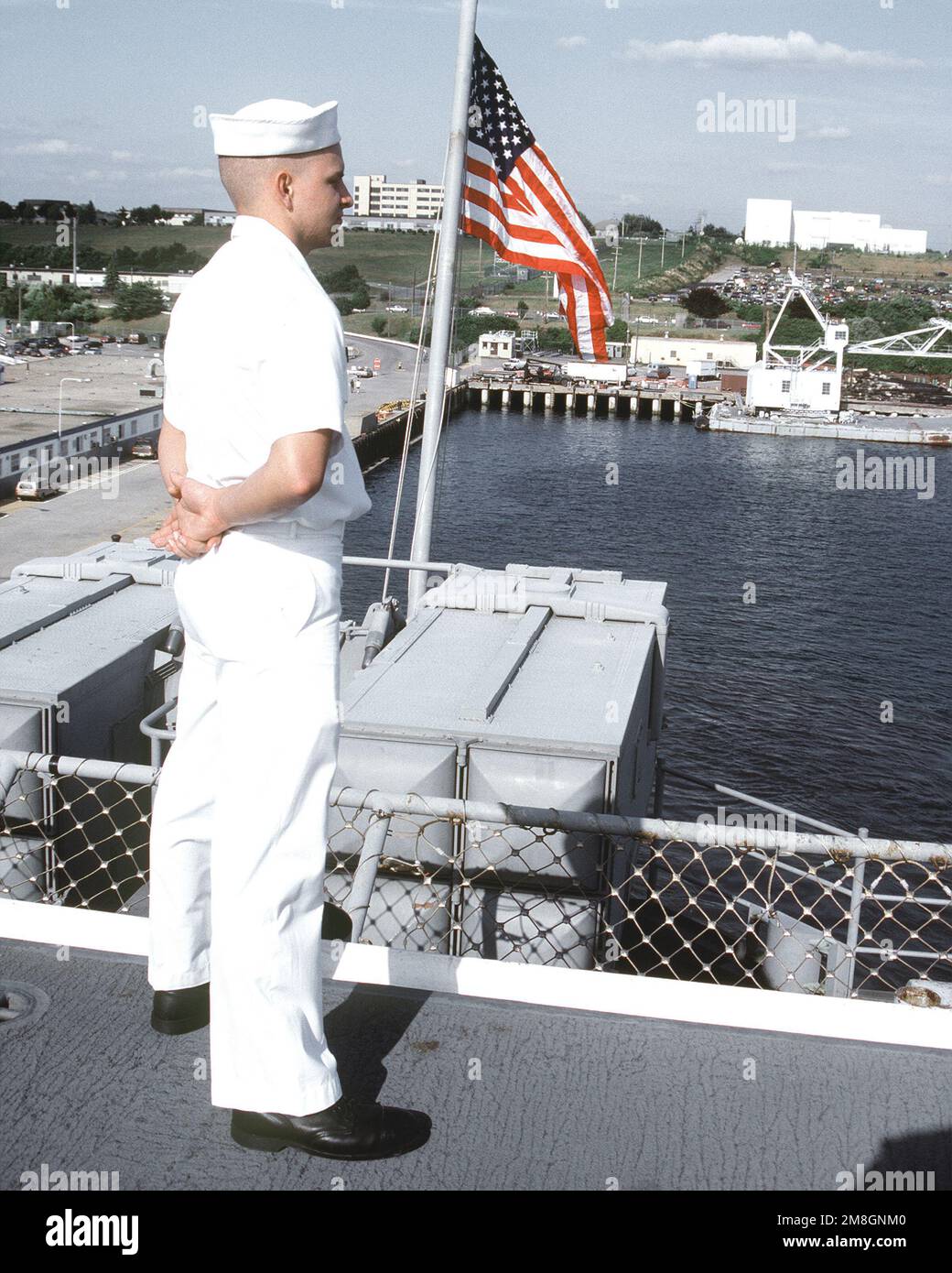 A crewman mans the fantail as the amphibious assault ship USS WASP (LHD ...