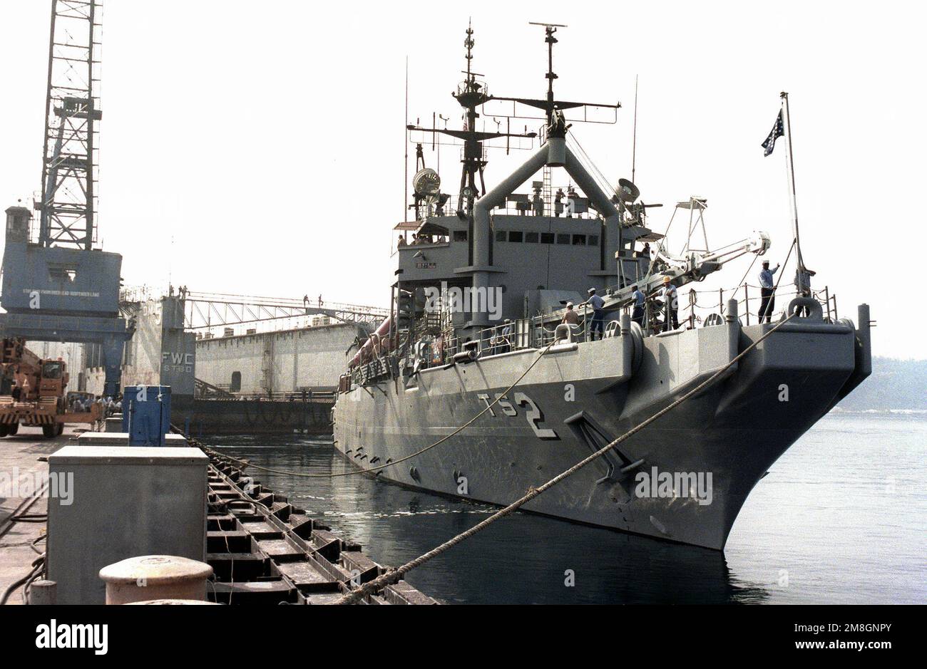 The salvage and rescue ship USS BEAUFORT (ATS-2) is moored to a pier ...
