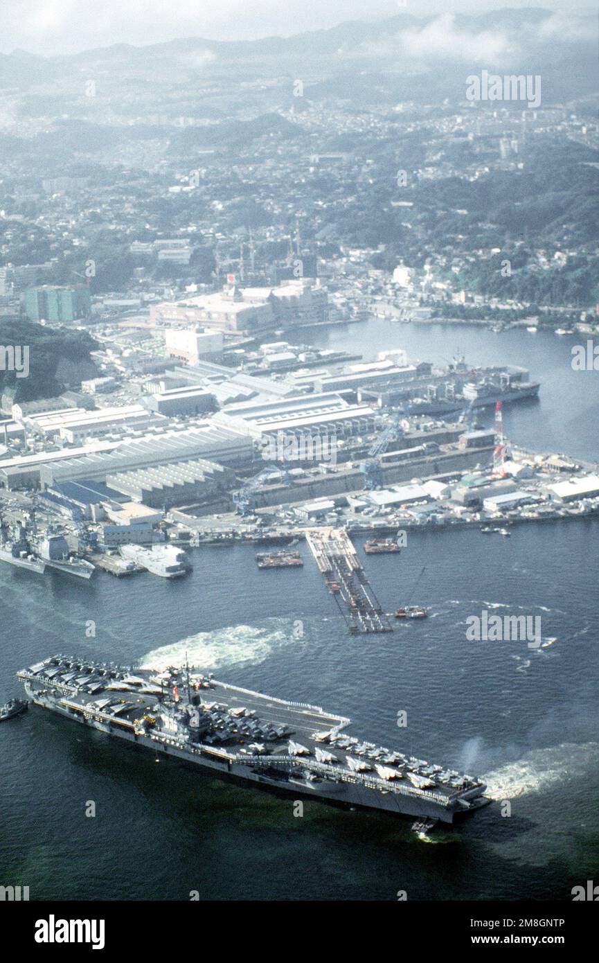 Large harbor tugs turn the aircraft carrier USS RANGER (CV-61) in ...