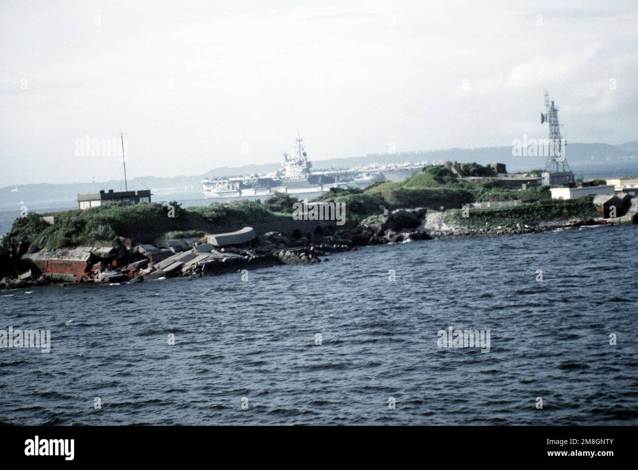 The aircraft carrier USS RANGER (CV-61) passes the remnants of a ...