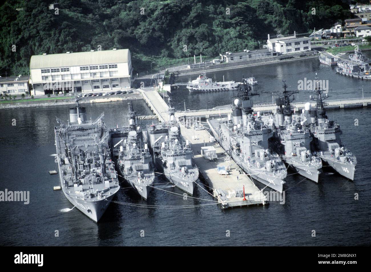 Ships of the Japanese Maritime Self-Defense Force (JMSDF) stand moored ...