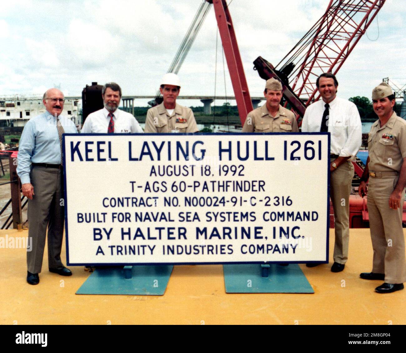 U.S. Navy and civilian officials pose for a group photograph during the ...