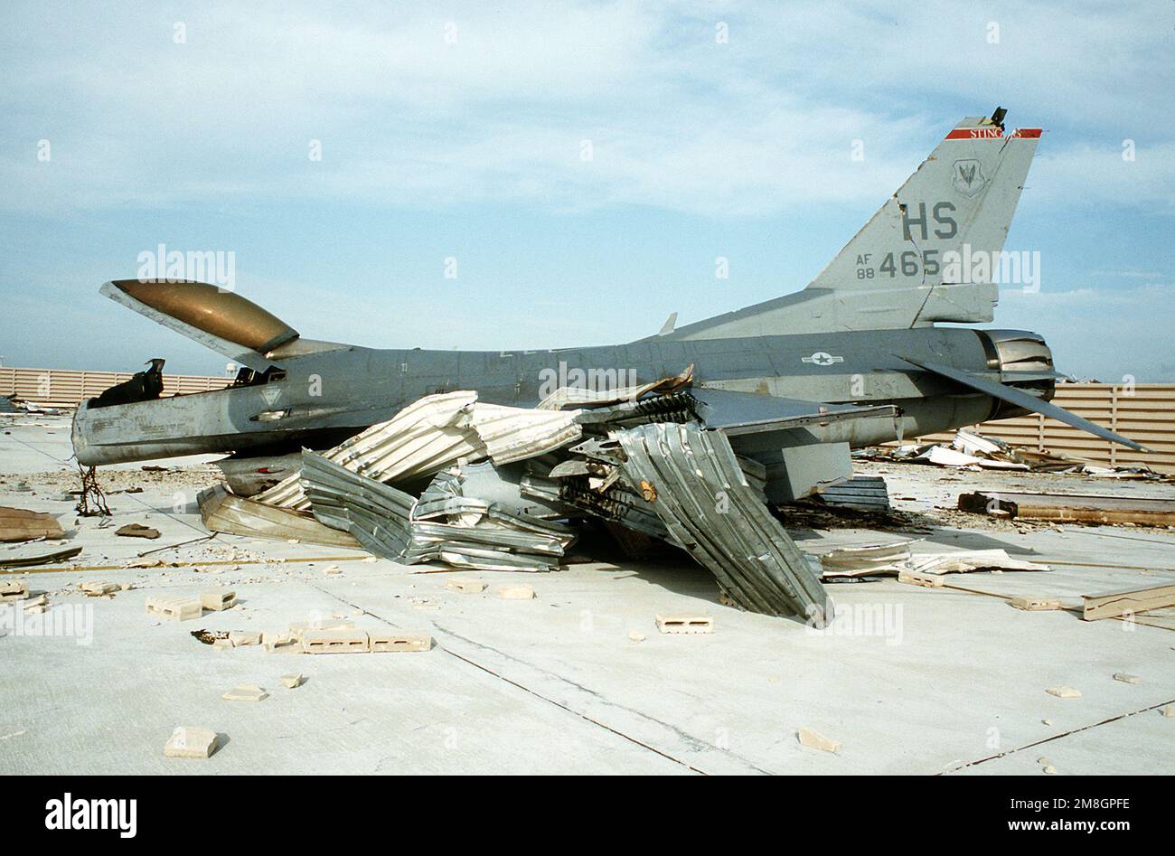 A destroyed F-16C Fighting Falcon aircraft lies on the tarmac in the ...