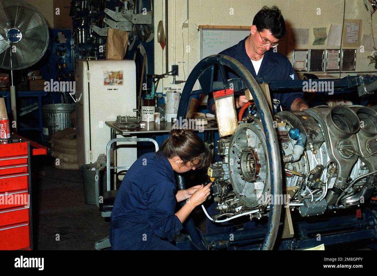 Aviation machinist mate service an aircraft engine. Base: Naval Air ...