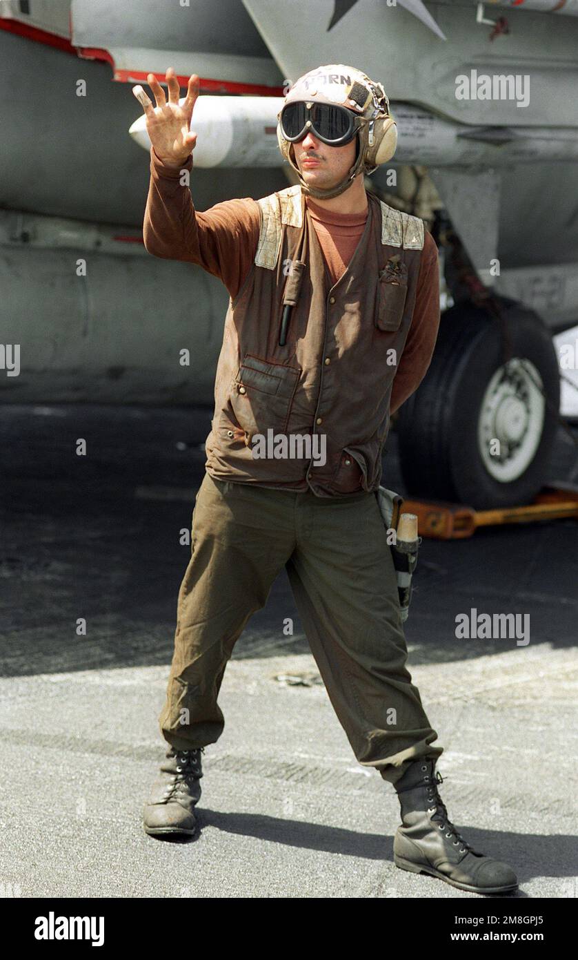 AIRMAN Terry Horn of Fighter Squadron 21 (VF-21) used hand signals to ...