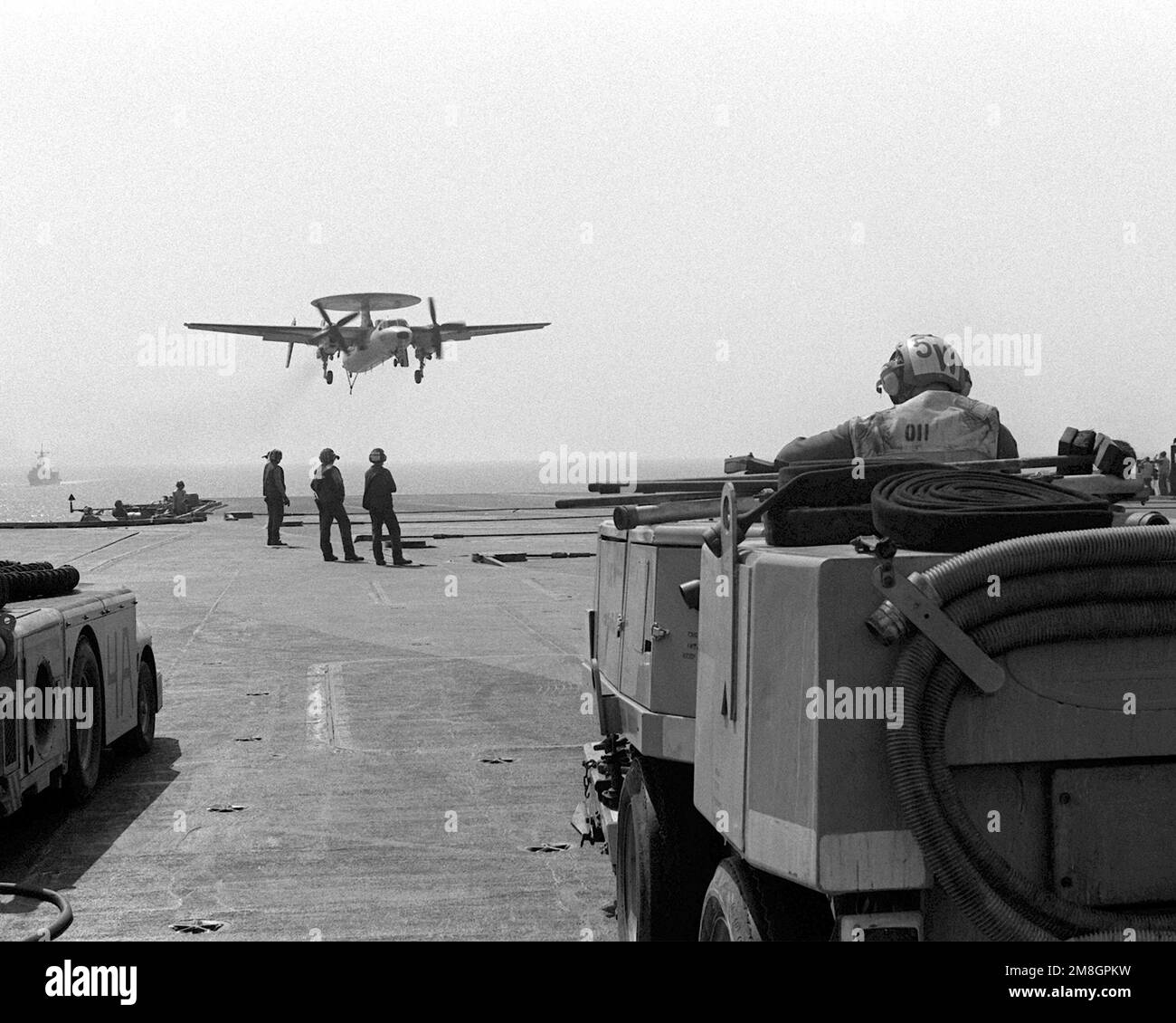 An E-2C Hawkeye aircraft approaches the flight deck of the aircraft ...