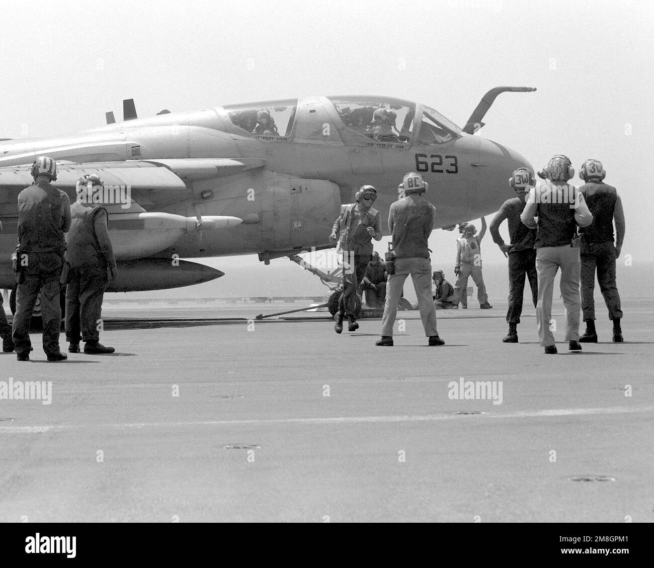Flight deck crewmen prepare a Tactical Electronic Warfare Squadron 136 ...
