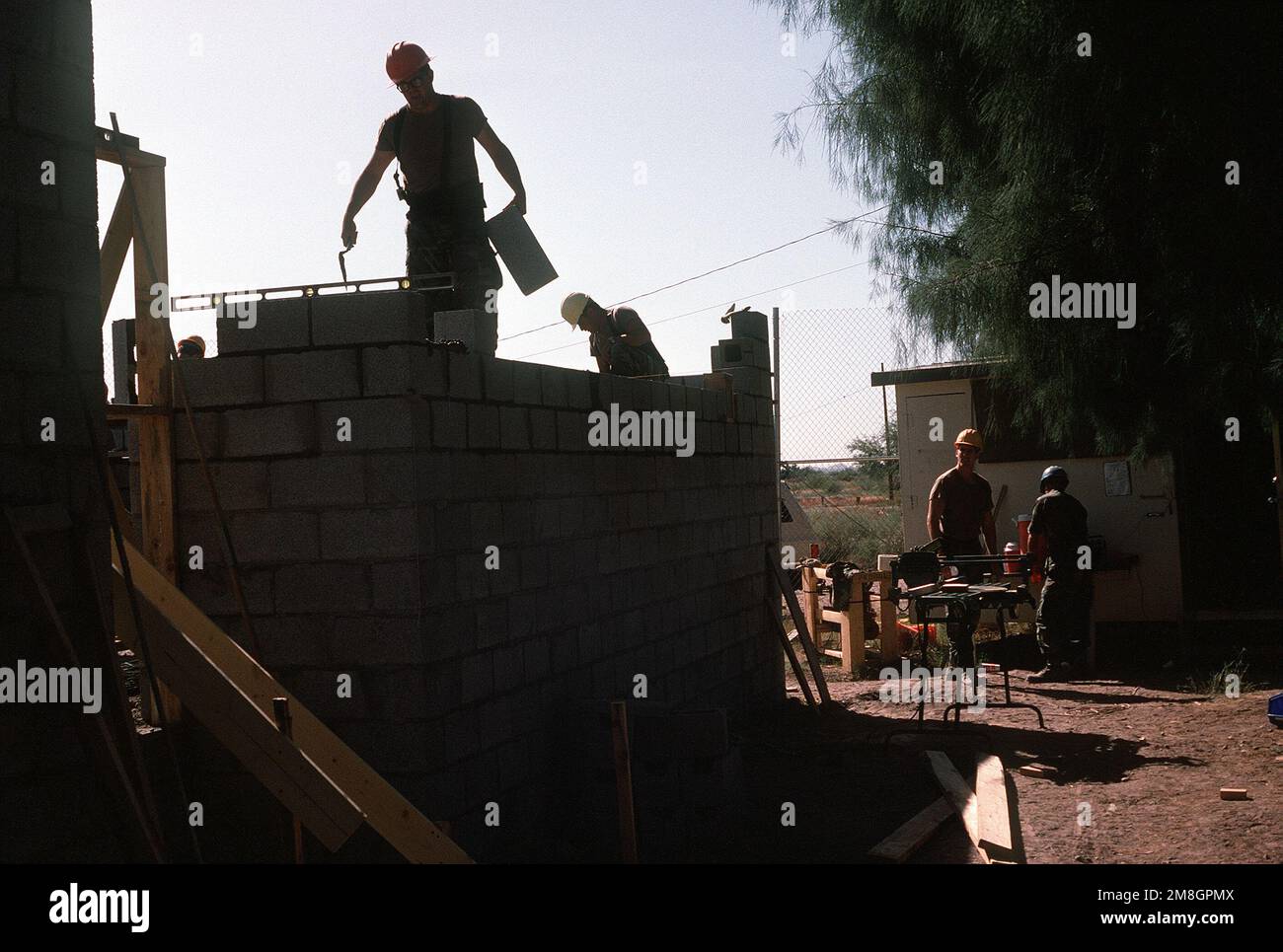 Members of the 82nd Civil Engineering Squadron lay blocks for a wall as ...
