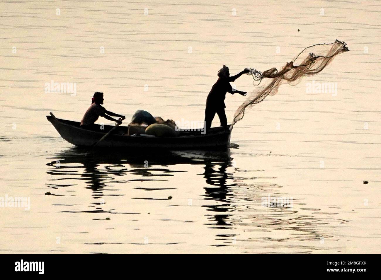 Rajasthan, India. 13th Jan, 2023. Indian fishermen catch fish on a lake ...