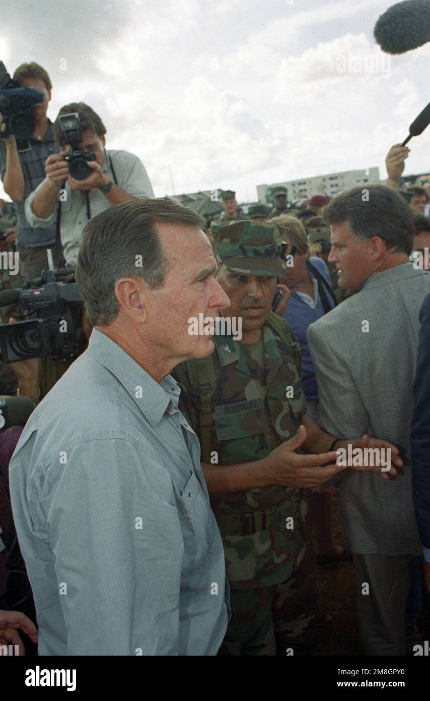 An Army officer speaks with President George Bush as the chief ...