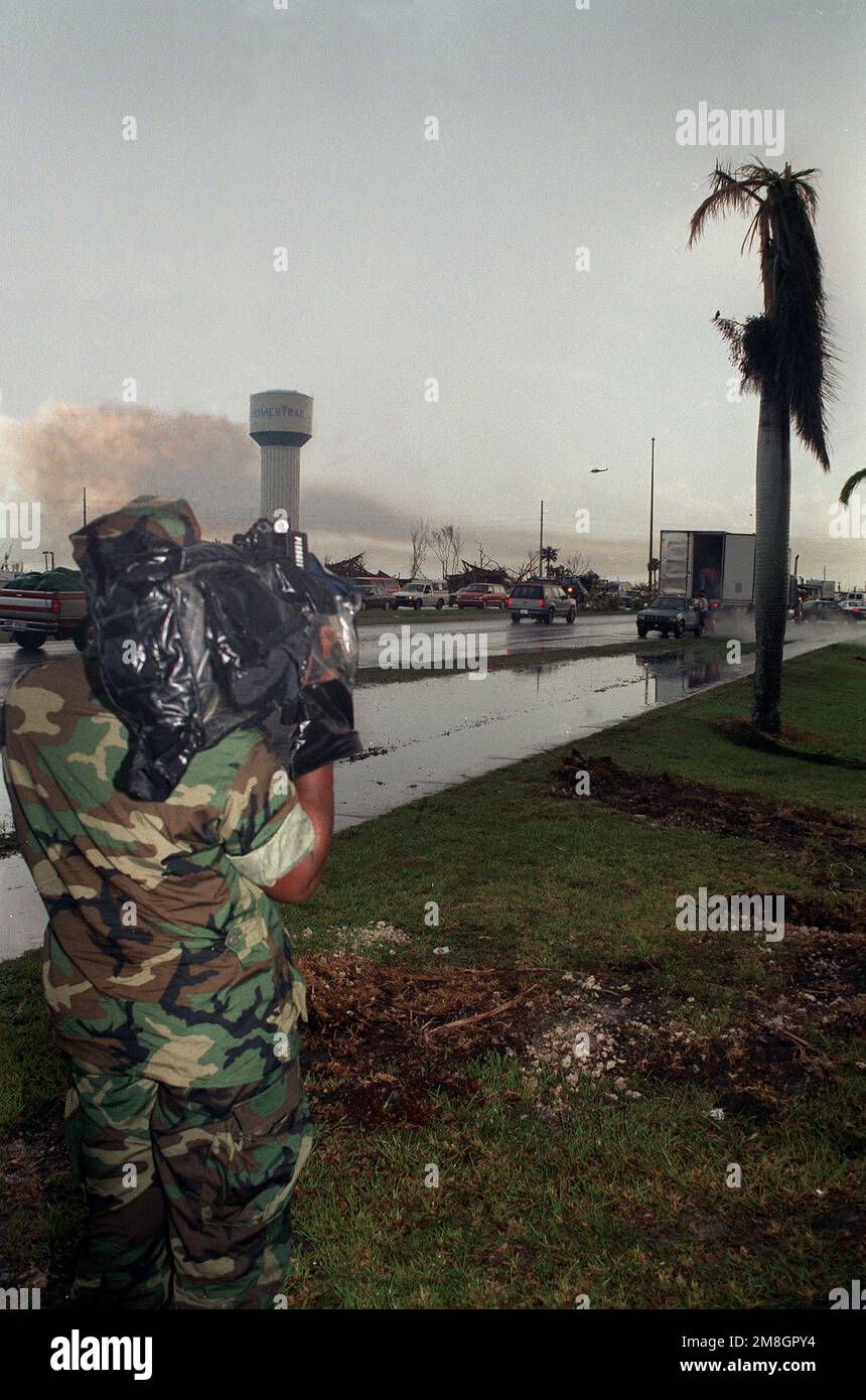 A cameraman videotapes disaster relief efforts in the aftermath of ...