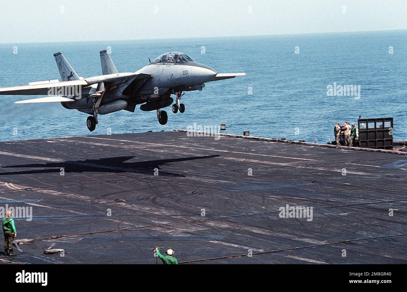 A Fighter Squadron 21 (VF-21) F-14 Tomcat aircraft lands on the ...