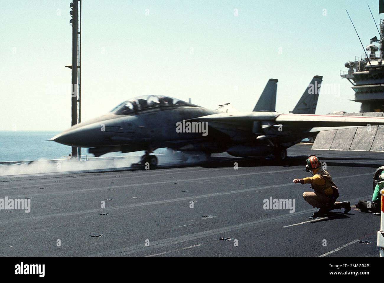 The launch officer gives the launch signal to the pilot of a Fighter ...