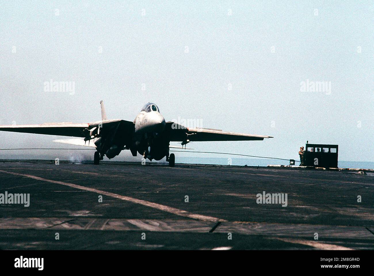 A Fighter Squadron 21 (VF-21) F-14 Tomcat aircraft hooks an arresting ...