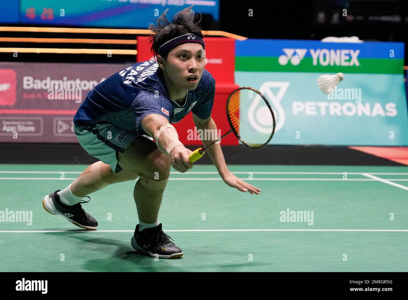 Japan's Kodai Naraoka plays a shot against Thailand's Kunlavut ...
