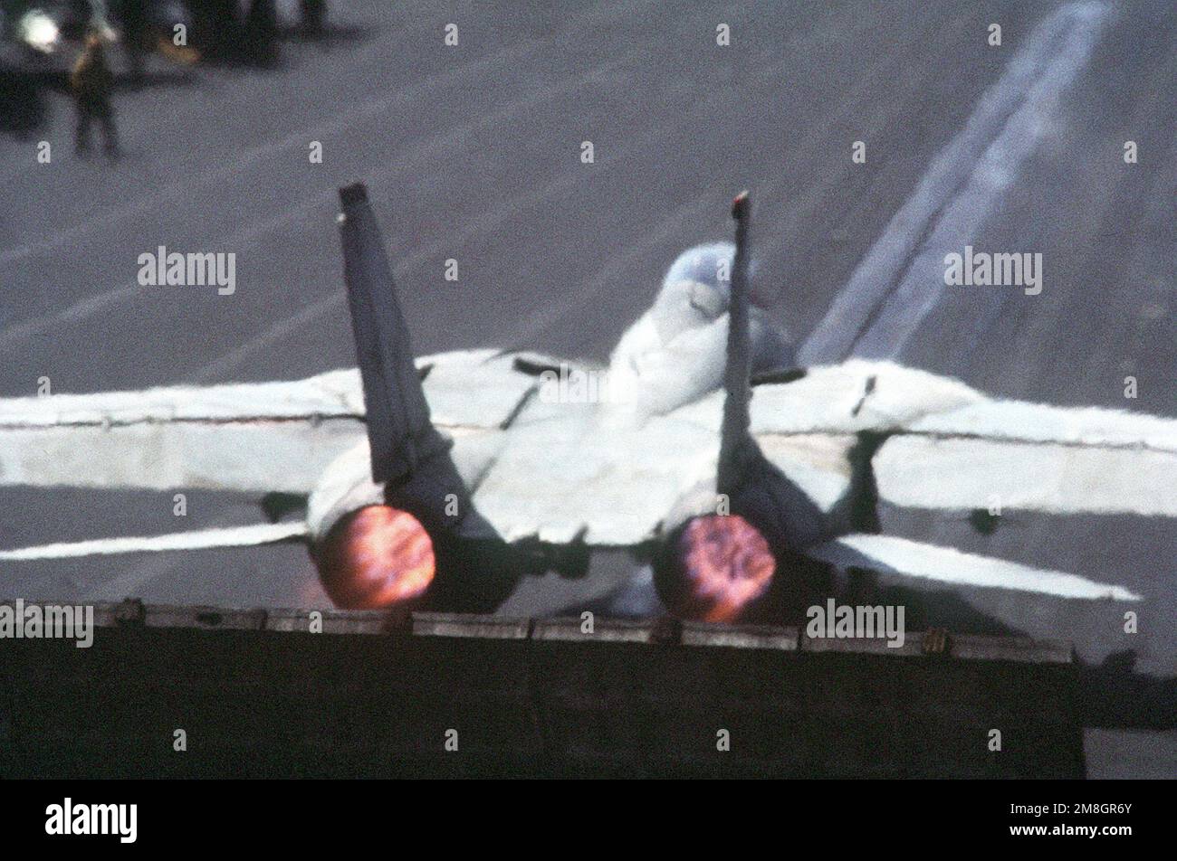 The pilot of an F-14 Tomcat aircraft waits for the launch signal on the ...