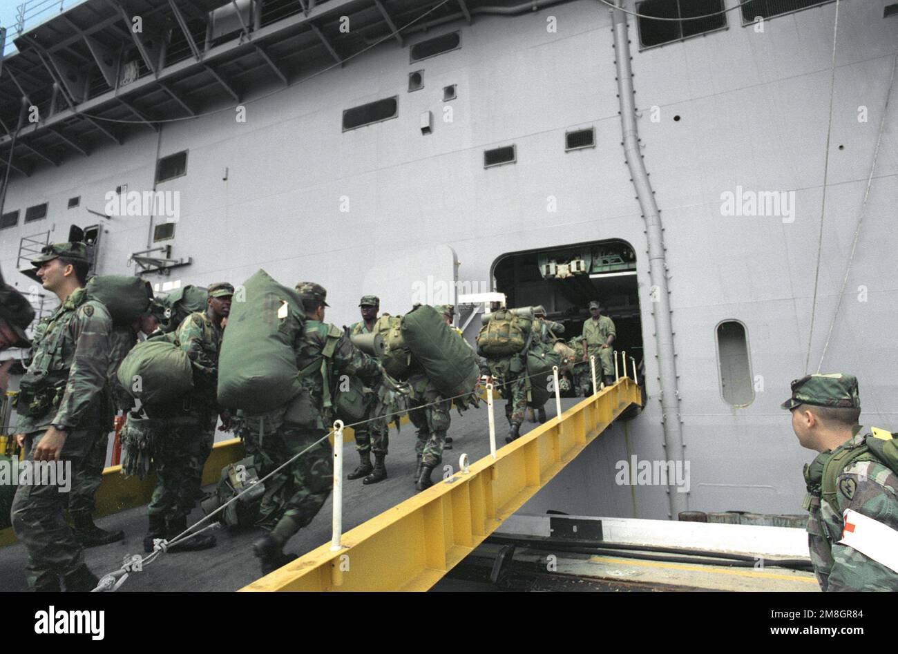 Troops of the 25th Infantry Division assemble on the pier as they ...