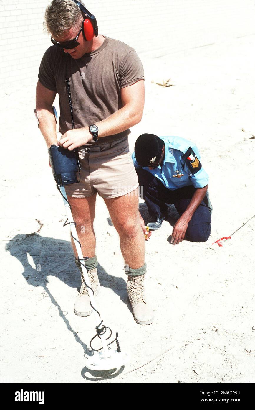 A US Navy Explosive Ordnance Disposal Team 3 member demonstrates the ...