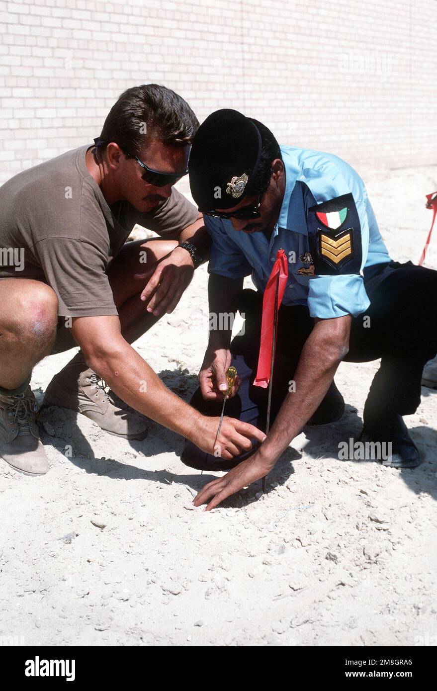 A member of Explosive Ordnance Disposal (EOD) Team 3 demonstrates how ...