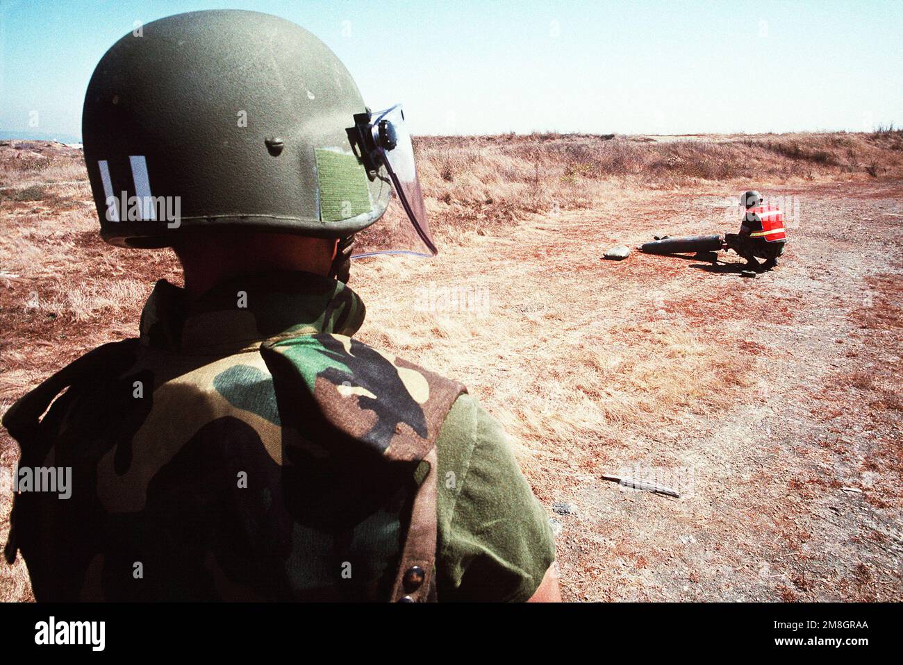 Navy EOD (explosive ordnance disposal) personnel disarm a practice ...