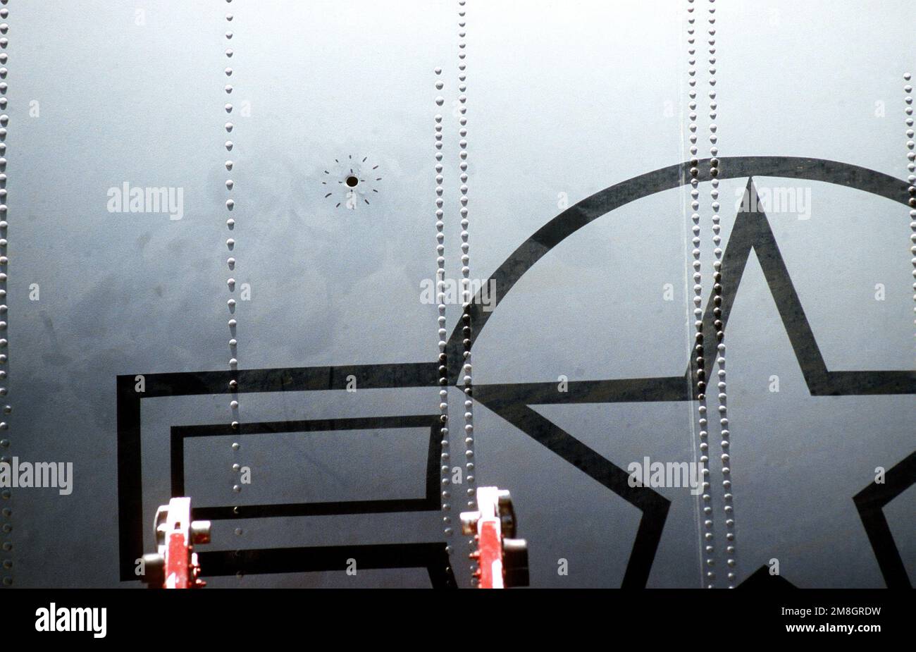 Pictured is a bullet hole in the fuselage of a US Air Force C-130. The ...