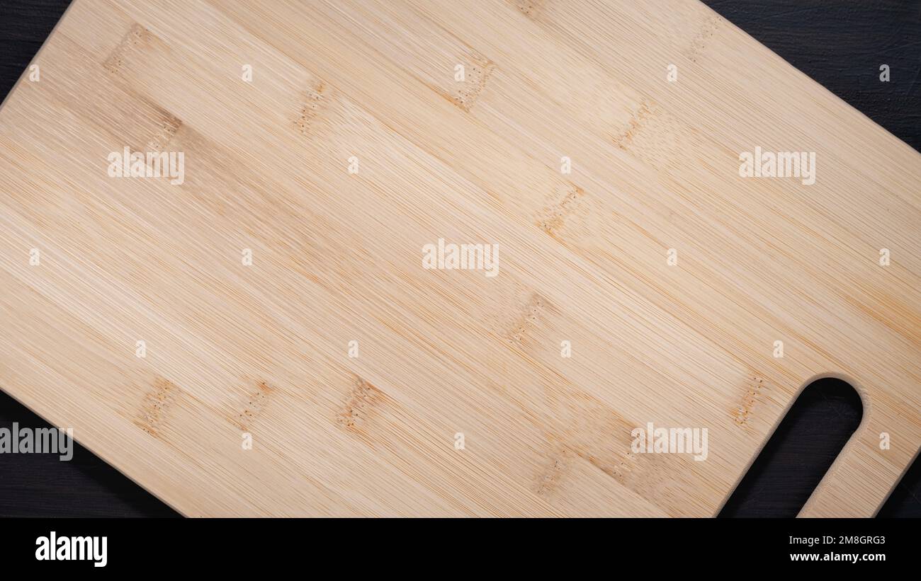 Empty wooden board on a black wood. Styled background for laying out ...
