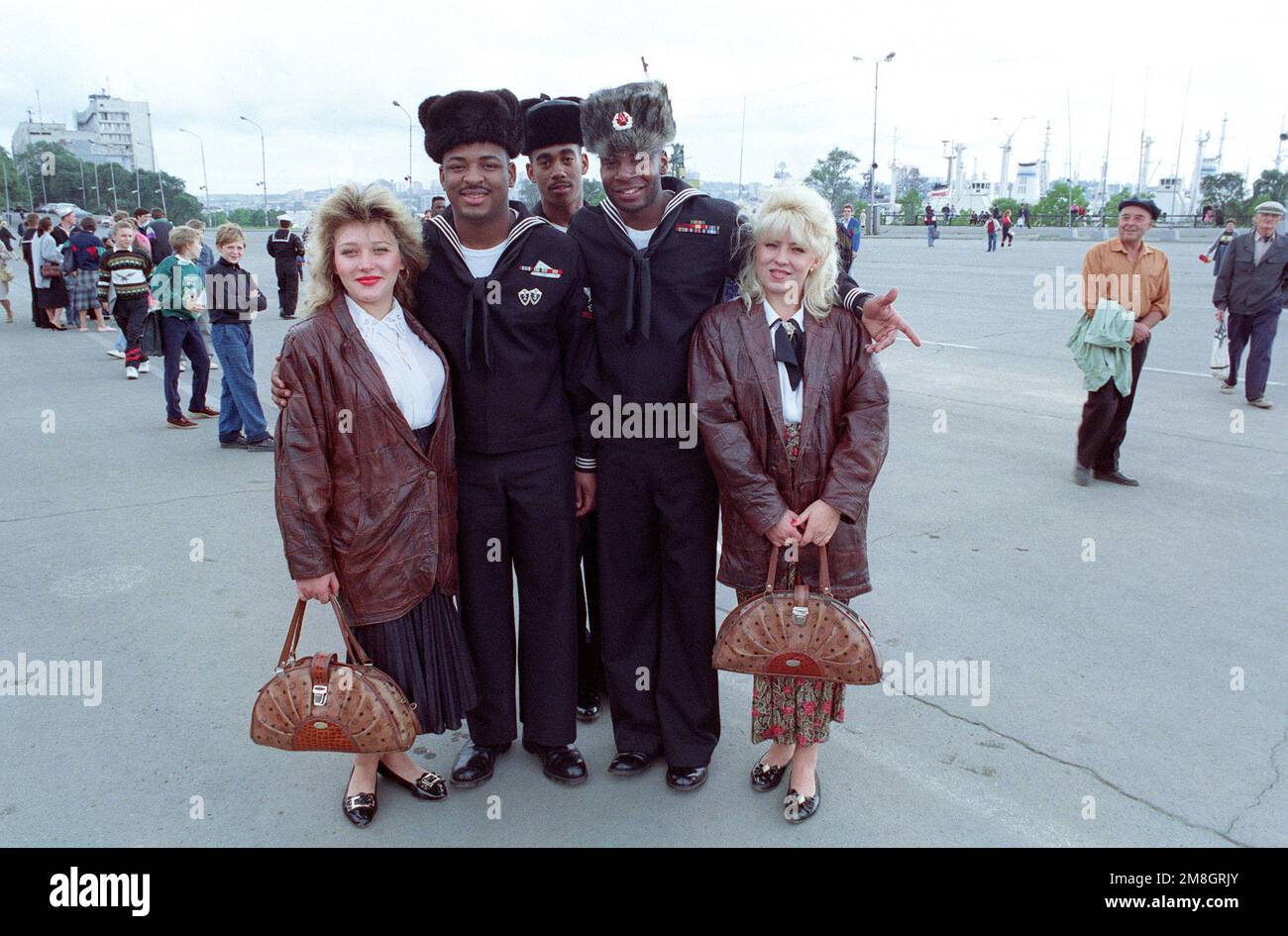 U.S. sailors sport Russian hats as they pose with local residents ...