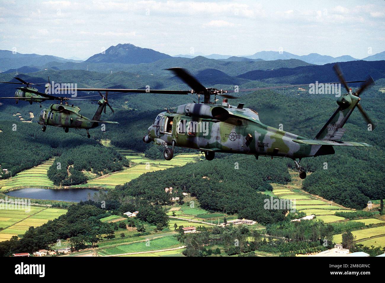 An air-to-air left side view of three 38th Air Rescue Squadron HH-60G Pave Hawk helicopters ...
