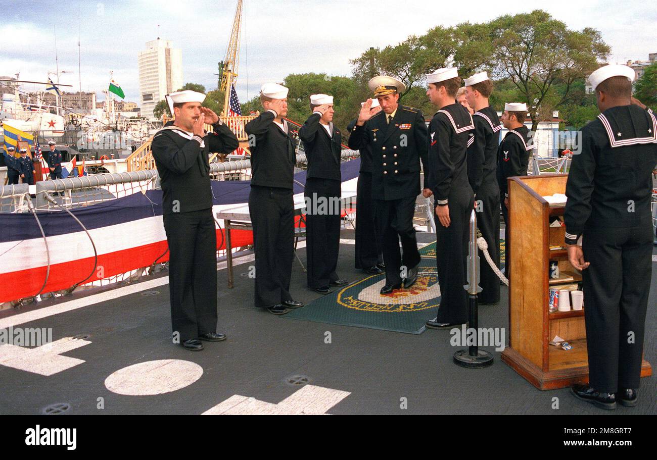Sideboys salute as a Russian naval officer is piped aboard the guided ...