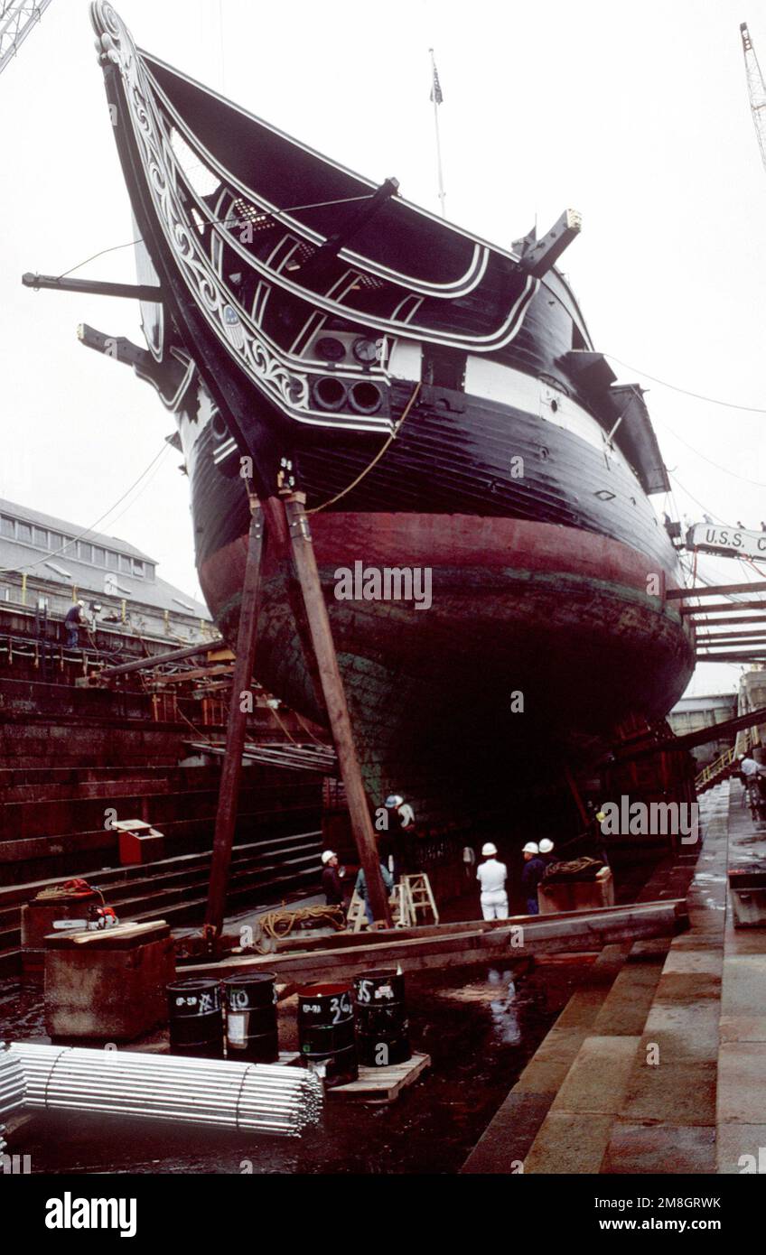 Workers inspect the copper sheathing protecting the hull of the 44-gun ...