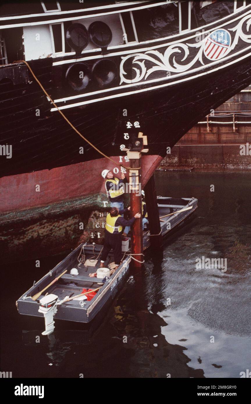 Workers position supports under the bow of the 44-gun sail frigate USS ...