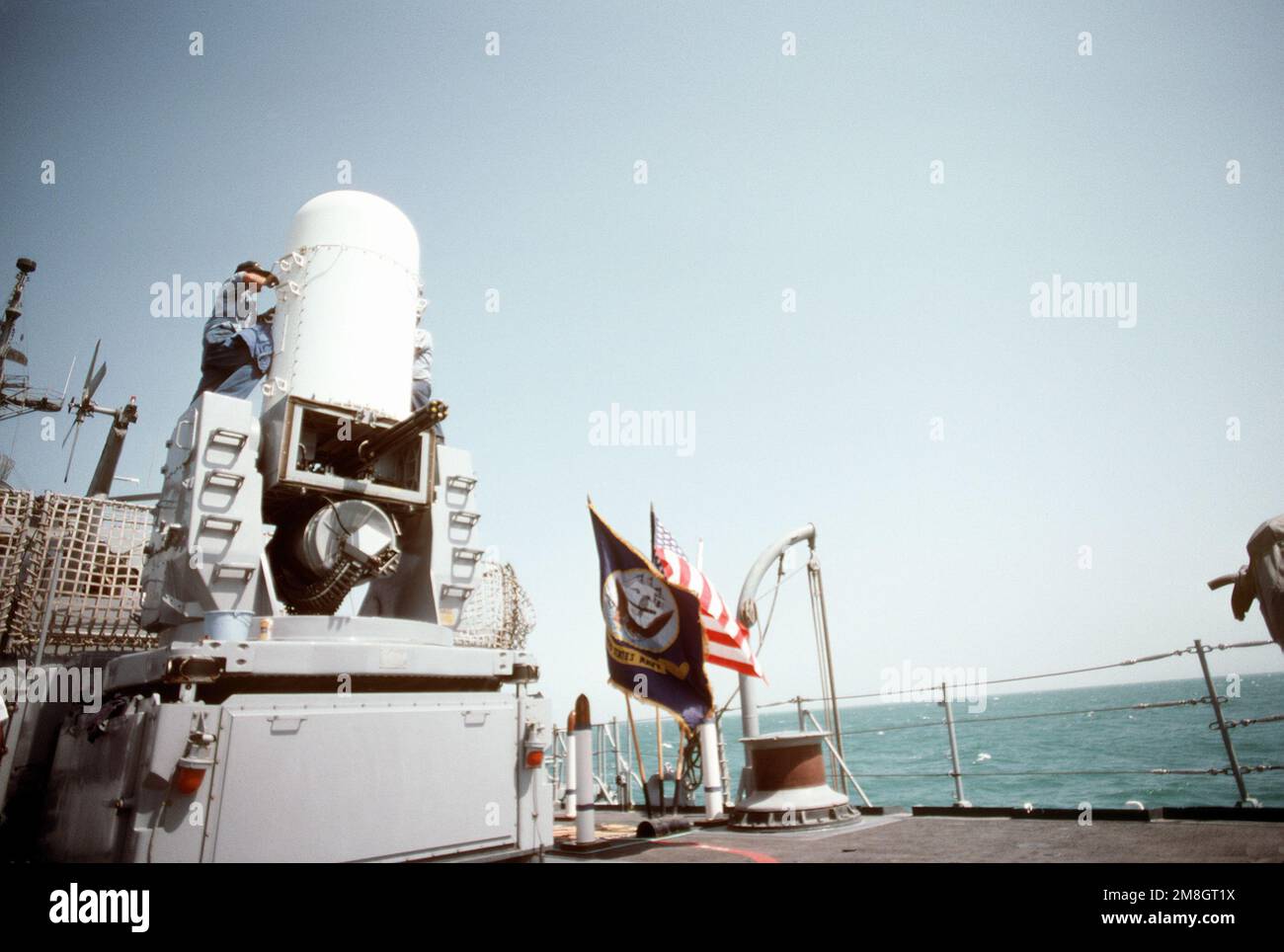 Crewmen inspect the stern-mounted Mk 15 Phalanx close-in weapon system ...