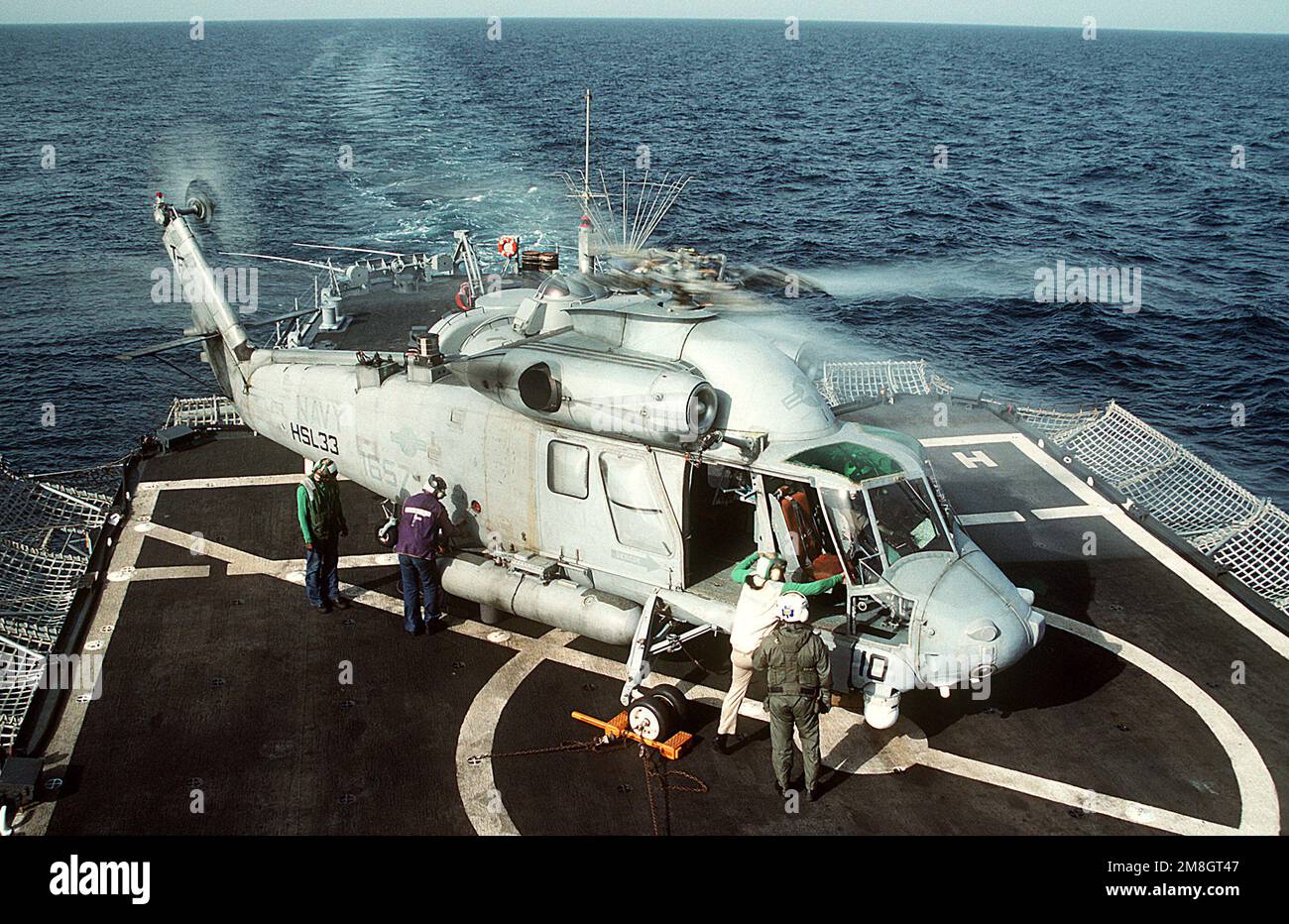 Flight deck personnel and the crew prepare a Light Helicopter Anti ...