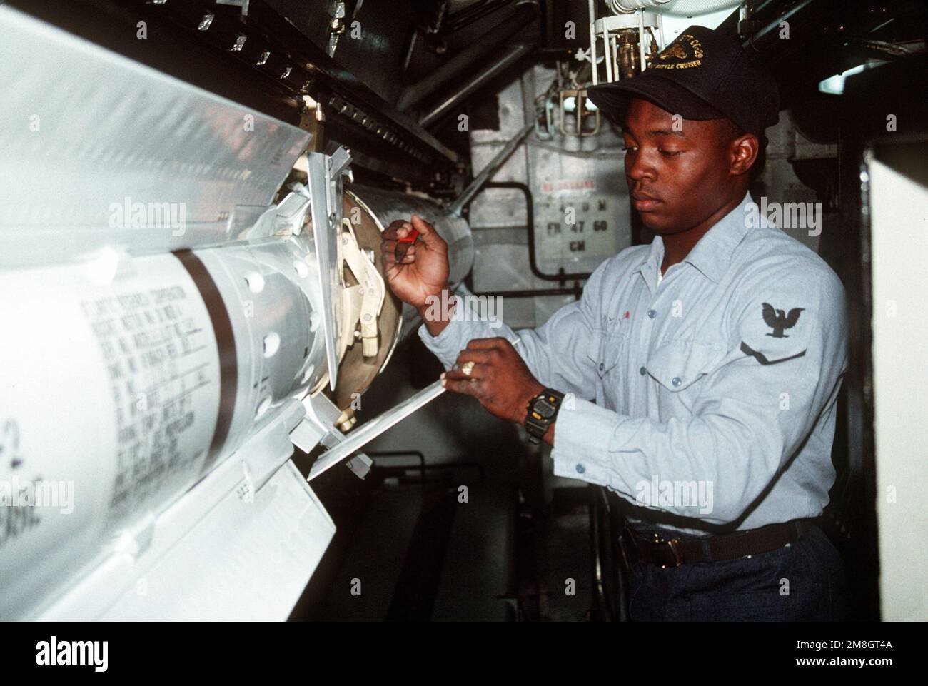 GUNNER's Mate 3rd Class James Pittman checks the 2nd stage fins of a ...