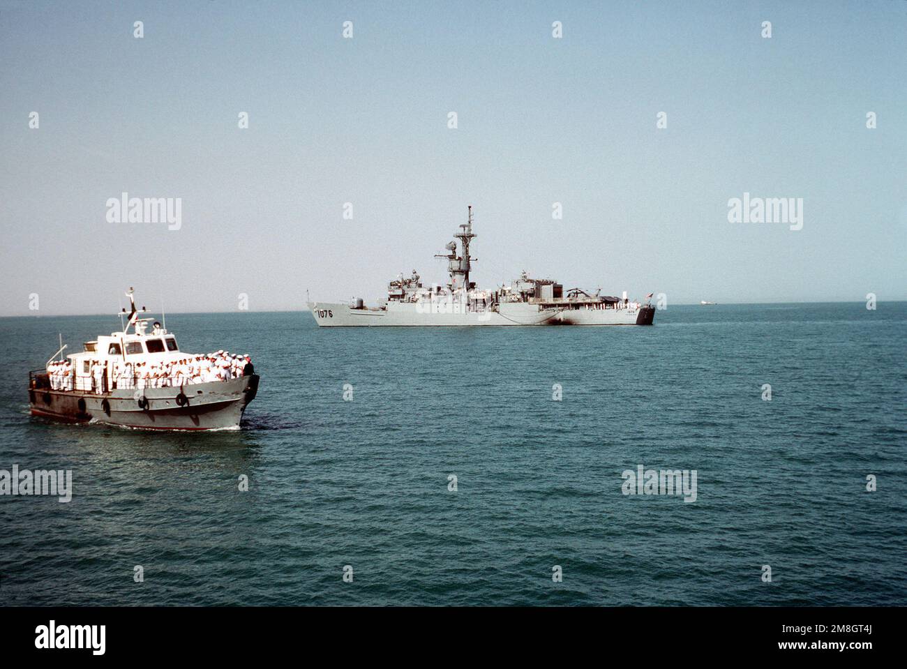 A Kuwaiti Coast Guard Patrol craft ferries sailors from the frigate USS ...