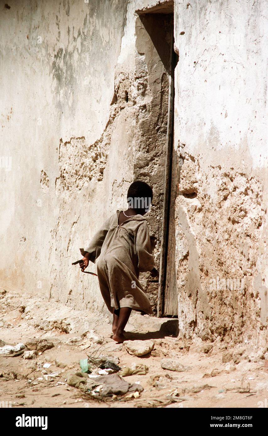 A young Somali child moves through the streets of Mogadishu. Subject ...