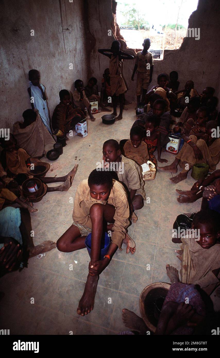 Refugees patiently wait for medical treatment at a refugee camp in ...