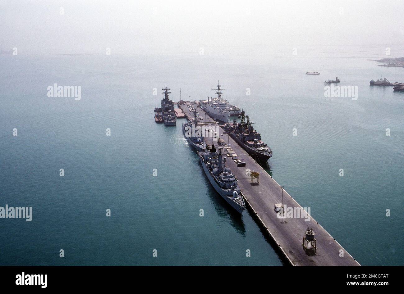 Various coalition ships are moored at Mina Salman while stationed in ...