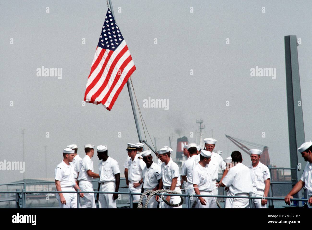 Crewmen stand easy on the stern of the destroyer USS KINKAID (DD-965 ...