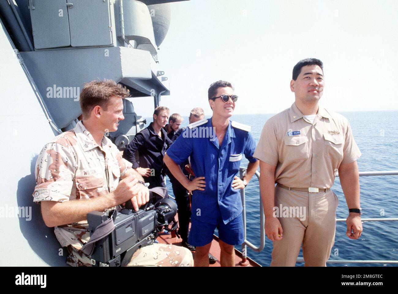 U.S. and Russian naval personnel watch from the fantail of the Russian ...