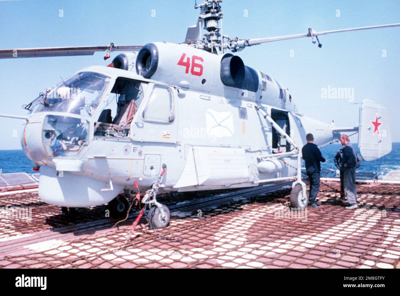 A Russian KA-27 Helix helicopter stands on the flight deck of the ...