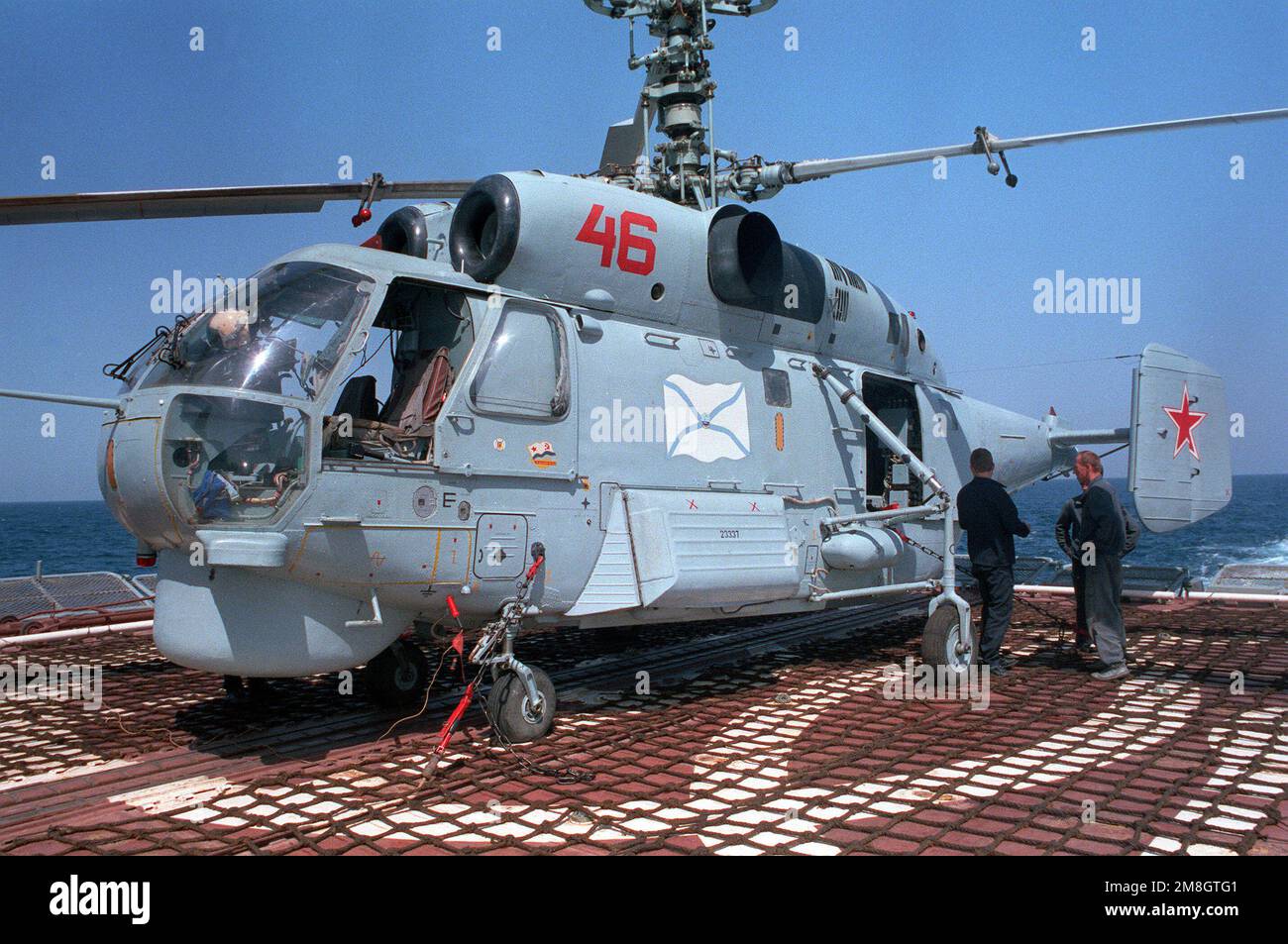 A Ka-27 Helix helicopter is parked on the fantail of the Russian guided ...