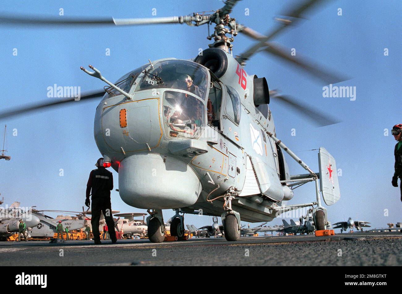 A Ka-27 Helix helicopter stands on the flight deck of the aircraft ...