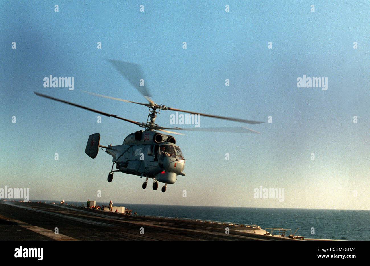 A Russian Ka-27 Helix helicopter takes off from the flight deck of the ...