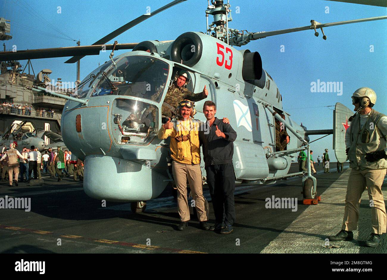 A crew member from the aircraft carrier USS RANGER (CV-61) and a ...