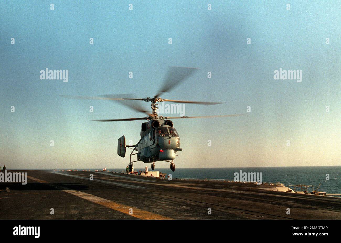 A Russian Ka-27 Helix helicopter takes off from the flight deck of the ...